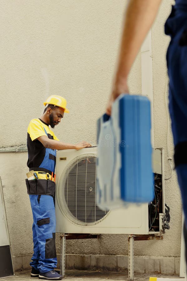 Serviceman Arriving To Help Apprentice Stock Photo - Image of ...