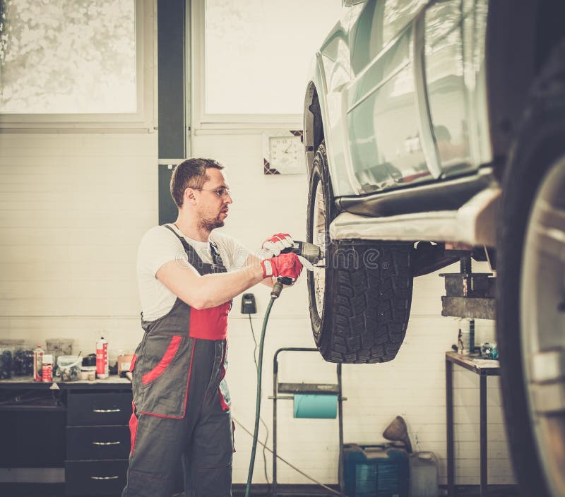 Serviceman in a Car Workshop Stock Image - Image of official ...