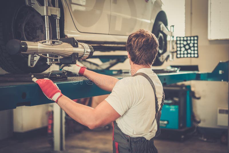 Serviceman in a Car Workshop Stock Photo - Image of alignment ...