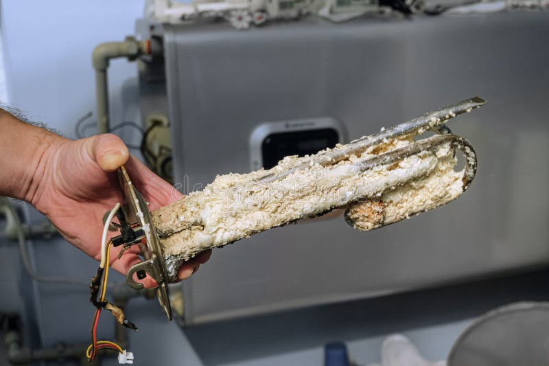 Serviceman Holds a Heating Element of an Electric Water Heater with a ...