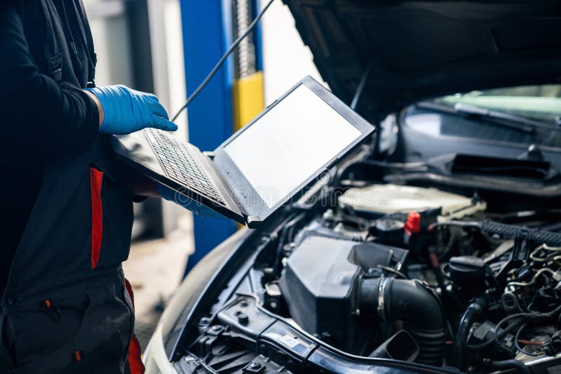 Serviceman with Laptop Checks Car Software in Car Service Stock Image ...
