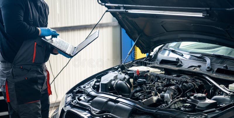 Serviceman with Laptop Checks Car Software in Car Service Stock Photo ...