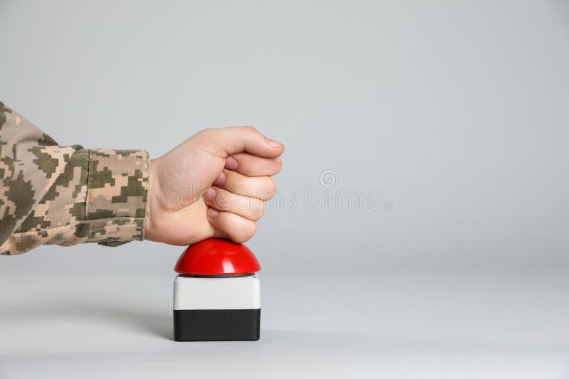 Serviceman Pressing Red Button of Nuclear Weapon at Black Table ...