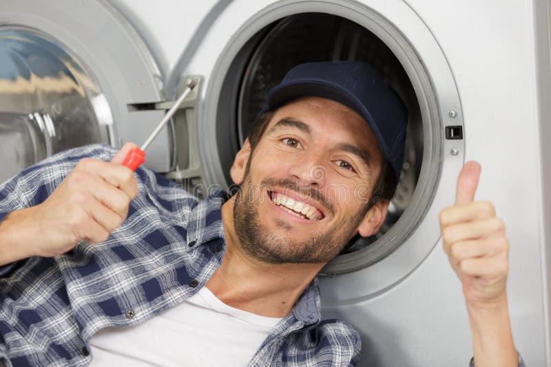 Serviceman by Washing Machine Holding Screwdriver with Thumbs Up Stock ...