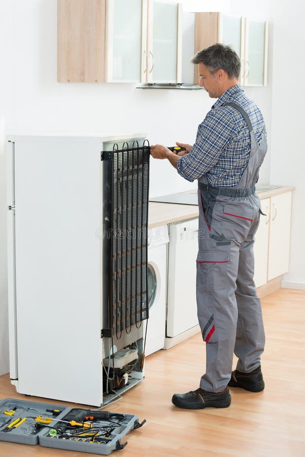 Serviceman Working on Fridge at Home Stock Image - Image of home ...