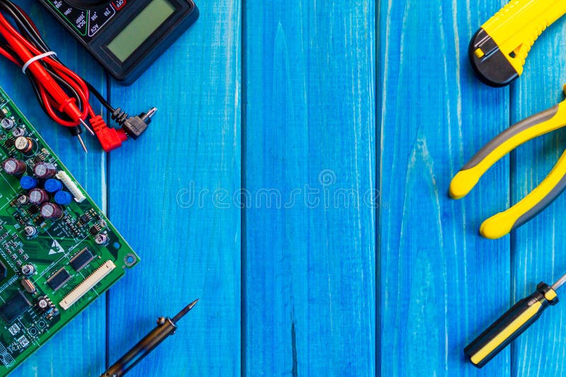 Services for the Production of Electronics and Repair on a Wooden Blue ...