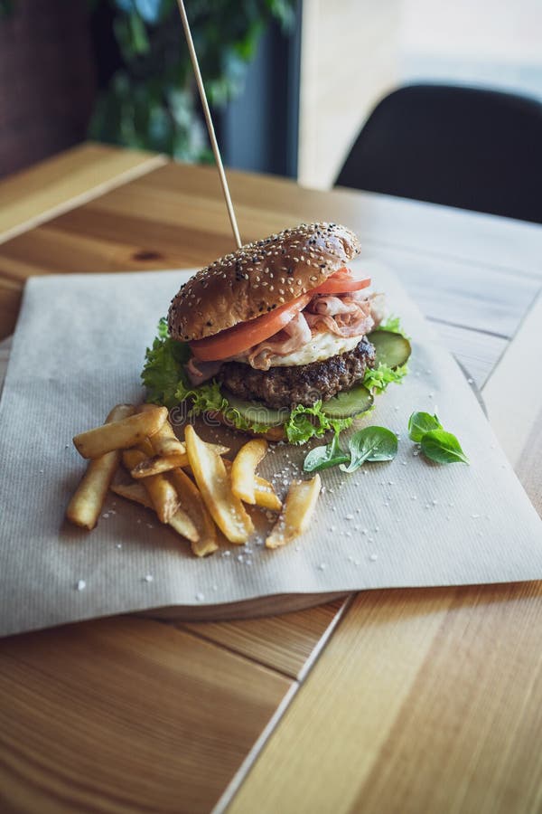 Serving Beef Burger with Fries in Restaurant. BBQ Beef Burger in Sezame ...