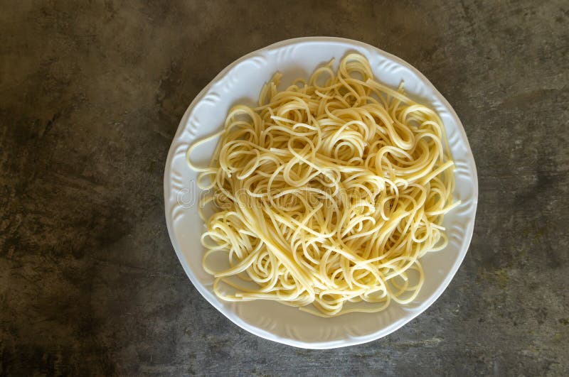 A Serving of Cooked Spaghetti on a White Plate on a Rustic Cement ...