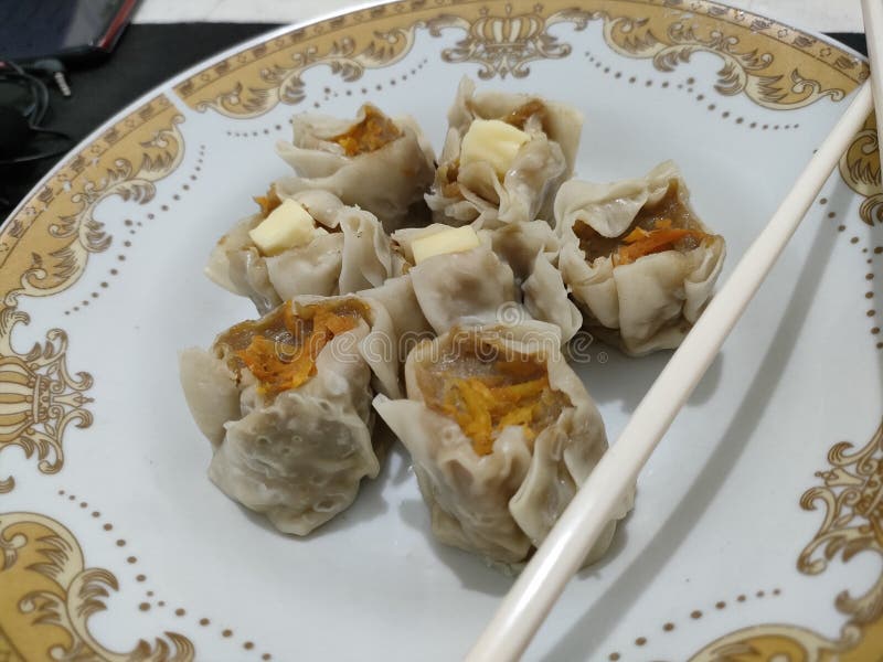 A Serving of Dim Sum Placed on a Patterned Glass Plate Stock Photo ...