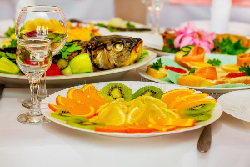 Serving the Festive Table in the Restaurant: Stuffed Fish, Citrus ...