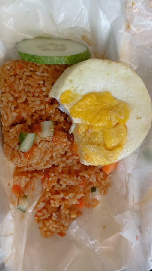 A Serving of Fried Rice Plus Slices of Cucumber and Sunny Side Up Eggs ...
