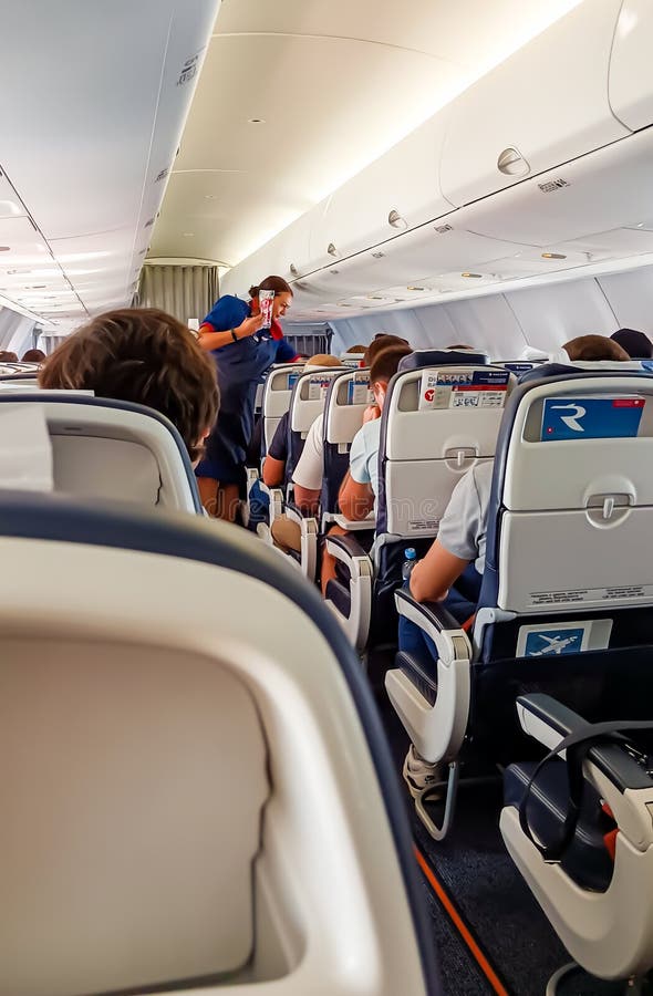 Serving Passengers on the Plane Editorial Stock Photo - Image of shelf ...
