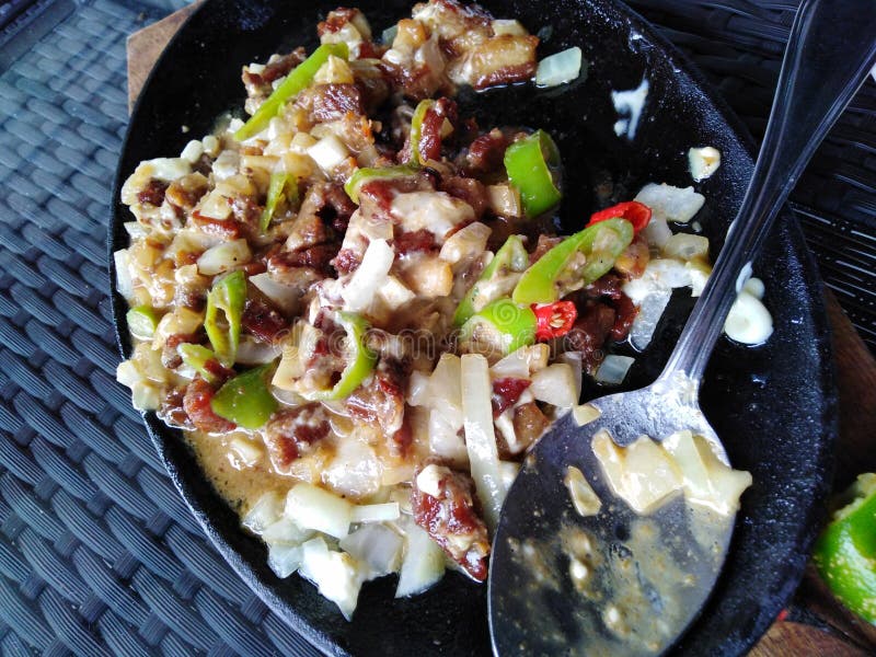 A serving of Pork Sisig stock photo. Image of spoon - 321266032