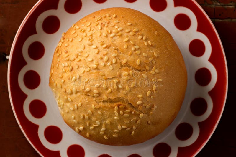 Sesame bun lays on a plate stock photo. Image of rustic - 85526362