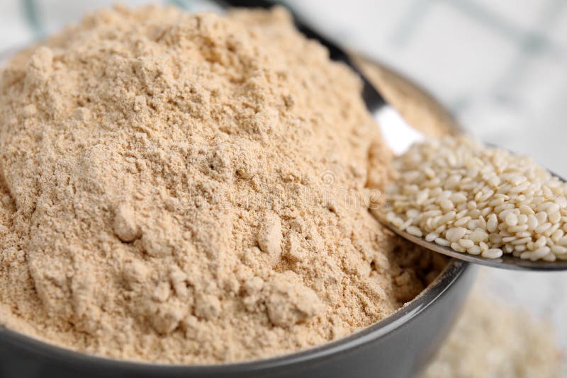 Sesame Flour in Ceramic Bowl and Spoon of Seeds, Closeup Stock Photo ...