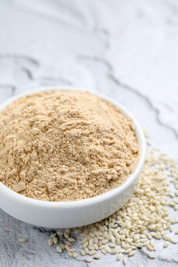 Sesame Flour in Ceramic Bowl on White Textured Table Stock Photo ...
