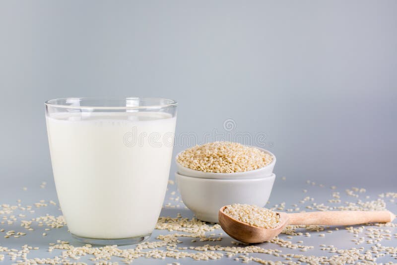 Sesame Milk in a Glass and Seeds in a Bowl on the Table. Dairy ...