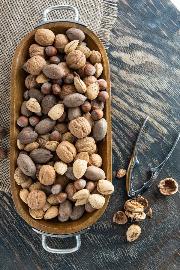 Set of Assorted Nuts in a Wooden Dish on a Dark Wooden Table Stock ...