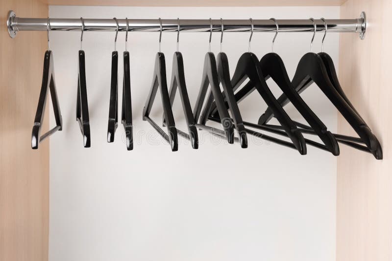 Set of Black Clothes Hangers on Wardrobe Rail Stock Image - Image of ...