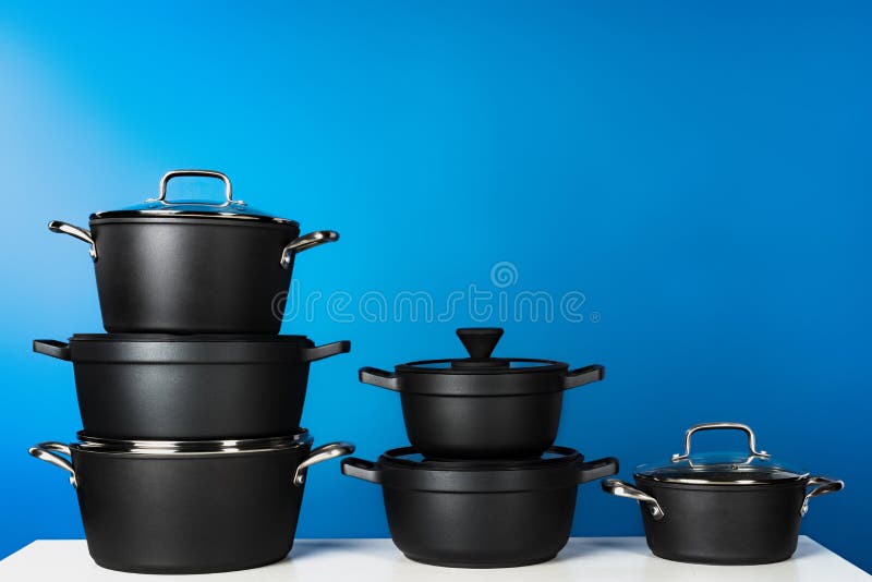 Set of Black Cookware Against Blue Background Stock Image - Image of ...