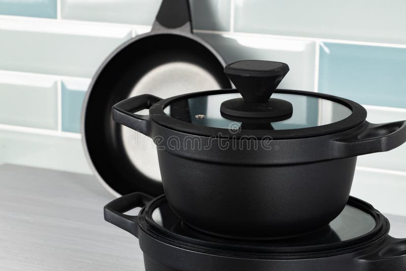 Set of Black Cookware on Kitchen Counter Stock Image - Image of ...