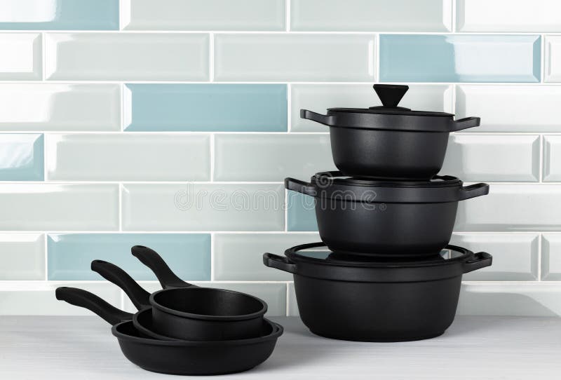 Set of Black Cookware on Kitchen Counter Stock Photo - Image of cooking ...