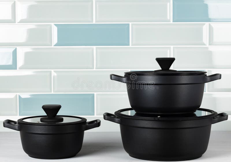 Set of Black Cookware on Kitchen Counter Stock Photo - Image of ...