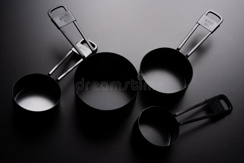 A Set of Black Measuring Cup on Black Background Stock Image - Image of ...