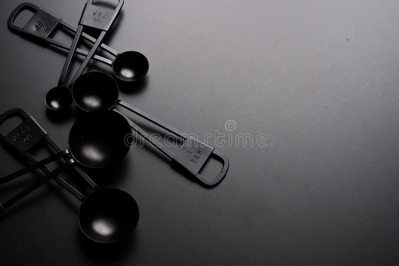 A Set of Black Measuring Spoon on Black Background Stock Image - Image ...