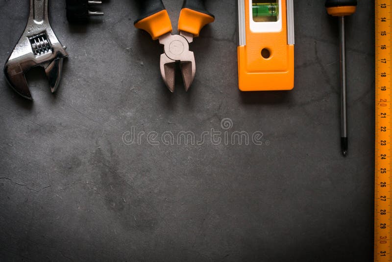 Set of Black and Orange Tools on Black Concrete Background Stock Image ...