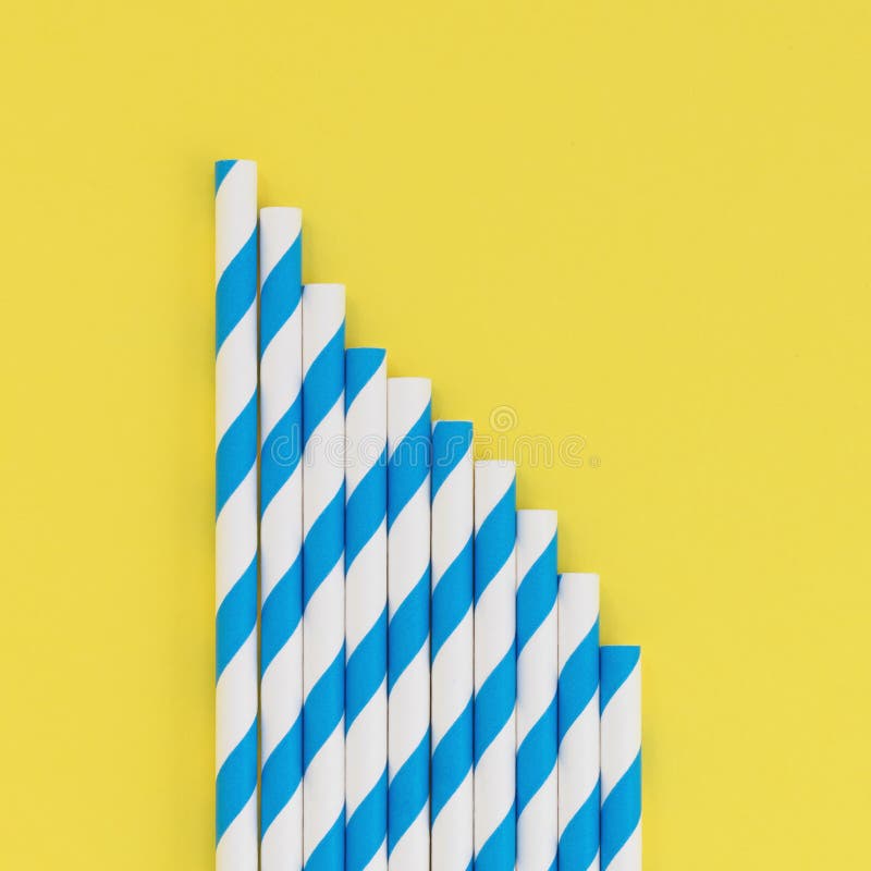 Set of Blue Striped Paper Straws on a Yellow Background Stock Photo ...