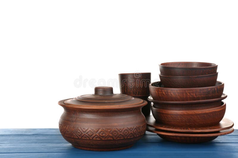 Set of Clay Dishes on Blue Wooden Table Against White Background Stock ...