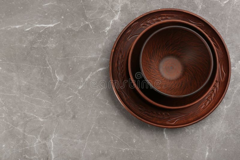 Set of Clay Dishes on Grey Marble Table, Top View. Space for Text Stock ...