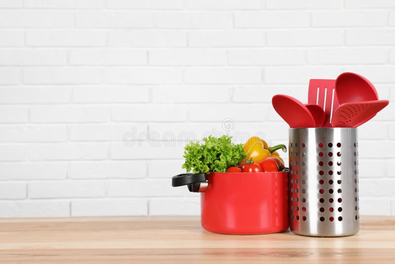 Set of Clean Cookware, Utensils and Vegetables on Table Against White ...