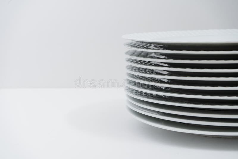 Set of Clean Stacked White Plates on a White Table. Copy Space Stock ...