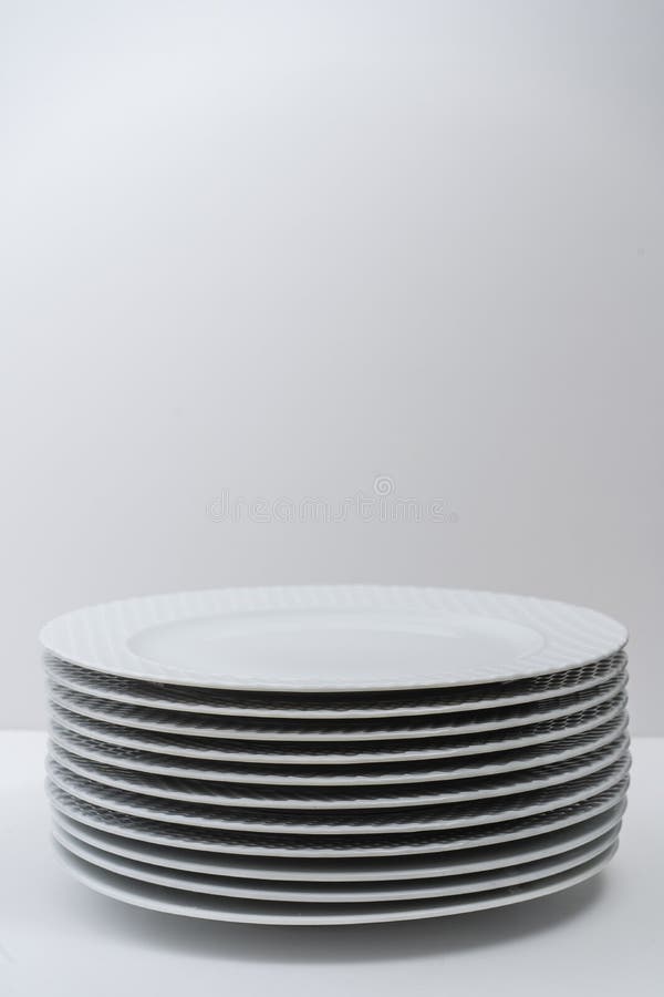 Set of Clean Stacked White Plates on a White Table. Copy Space Stock ...