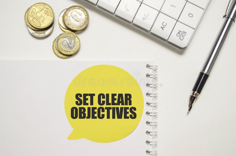 SET CLEAR OBJECTIVES on Yellow Sticker on Pen with Coin Stock Photo ...
