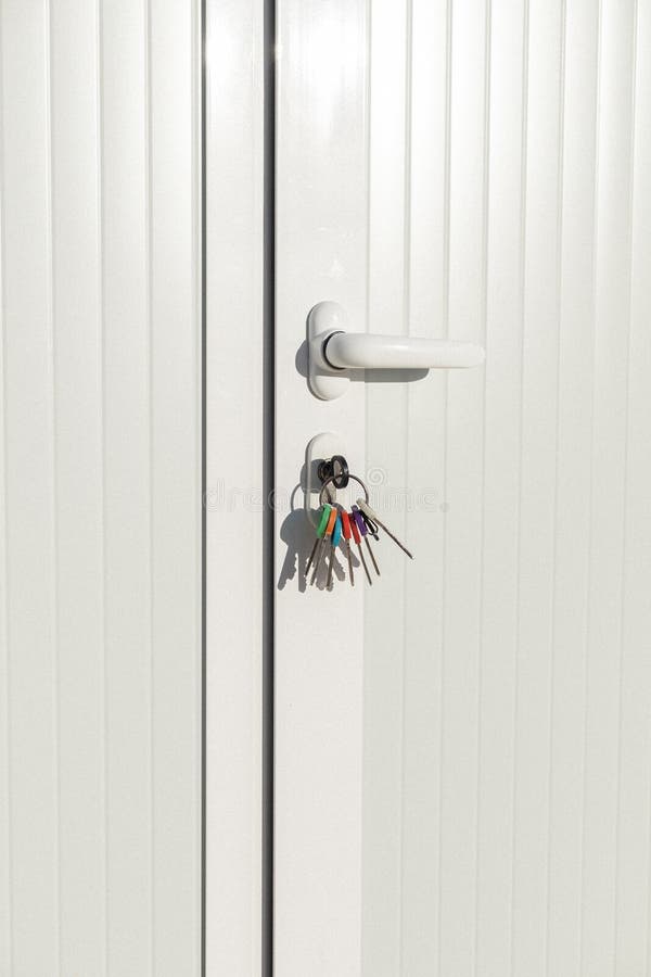 Set of Colored Keys Placed in the Lock of a Door To Open or Close the ...