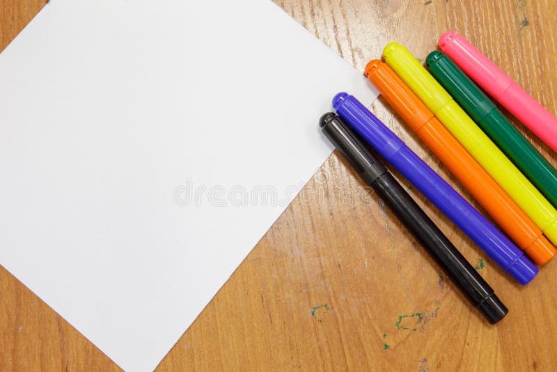 A Set of Colored Markers and a Sheet of White Paper on the Table. Stock ...