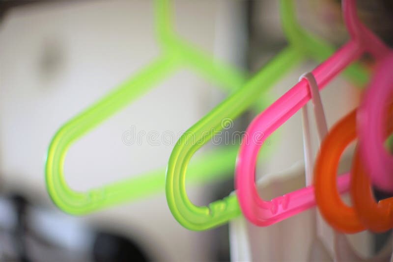 A Set of Colorful Plastic Hangers Hanging on the Rack Stock Image ...