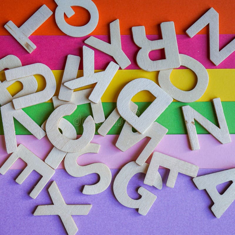 Set of Coloured Wooden Letters on a Rainbow Background Stock Image ...
