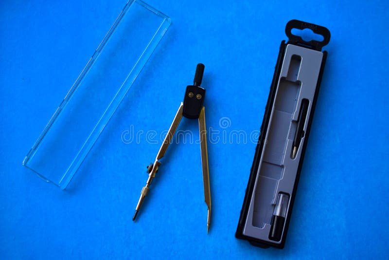 Set of Compasses in a Box on a Blue Background Stock Photo - Image of ...