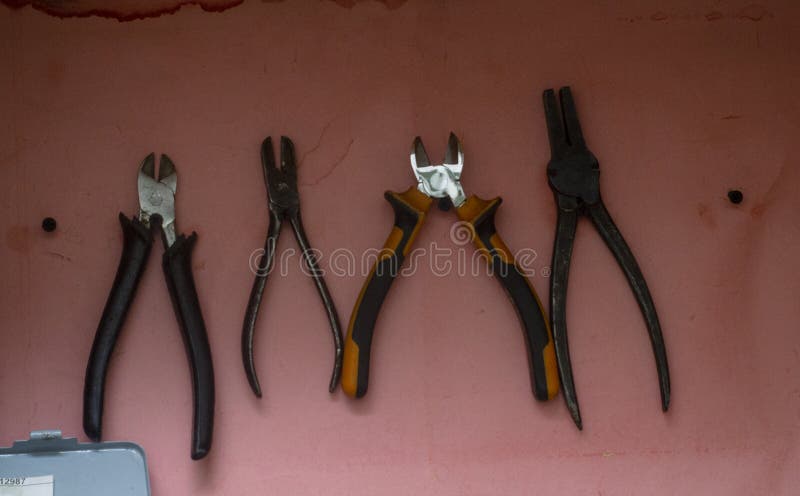 Set of Cutters and Pliers on the Stand or in the Closet in the ...