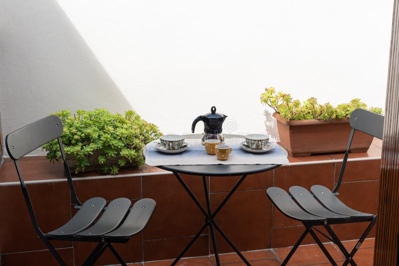 A Set of Decorated Coffee Cups with Coffemaker, on a Table Set for ...