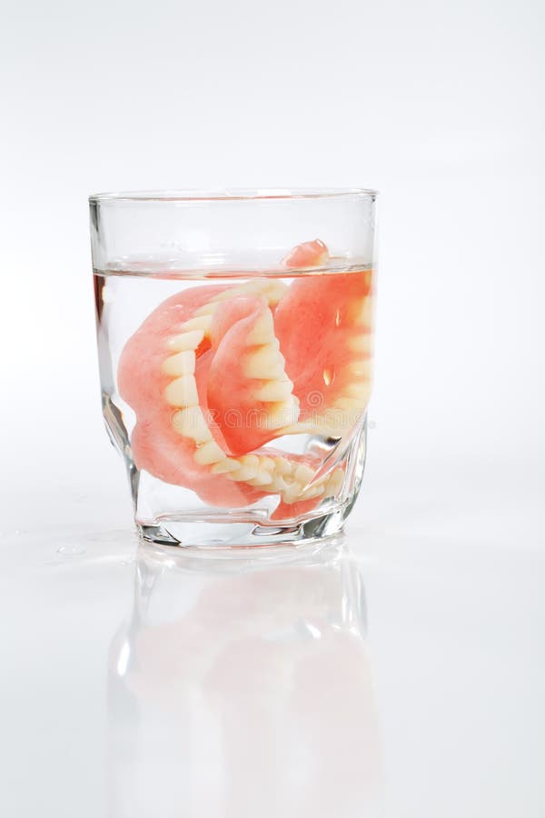 A Set of Dentures in a Glass of Water Stock Photo - Image of denture ...