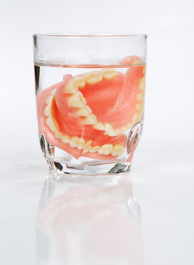 A Set of Dentures in a Glass of Water Stock Photo - Image of denture ...
