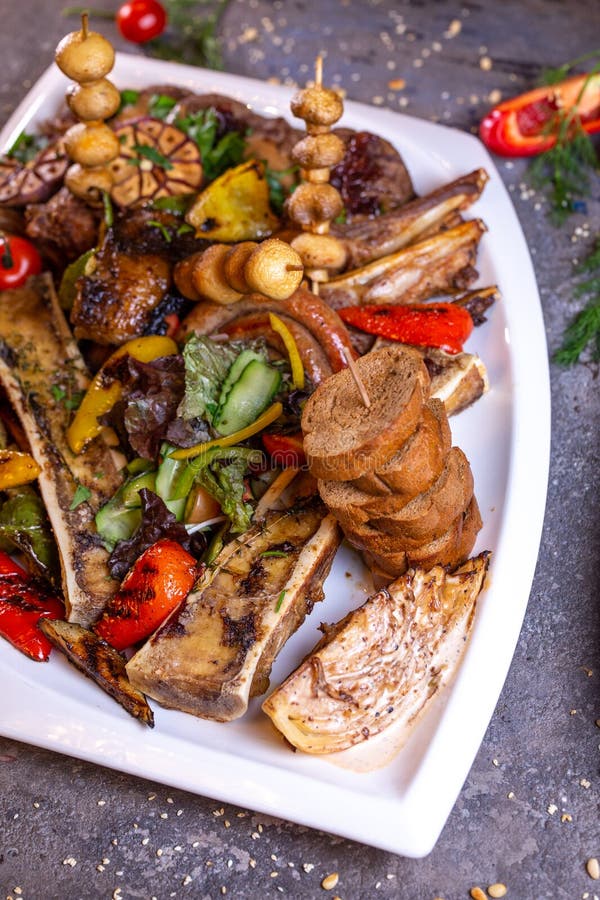 A Set of Different Beef Meat Dishes on a White Plate Stock Photo ...