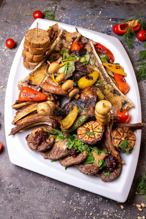 A Set of Different Beef Meat Dishes on a White Plate Stock Photo ...