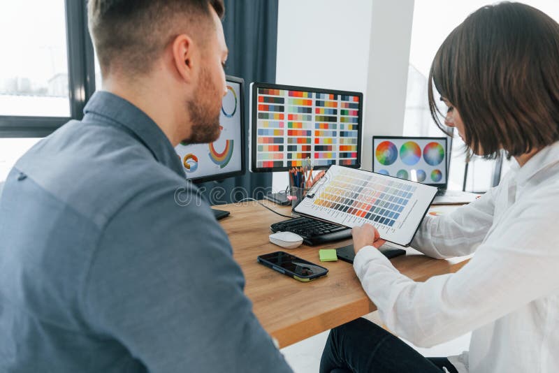 Set of Different Colors. Two Designers Working Together in the Office ...