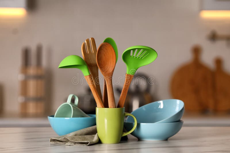 Set of Different Cooking Utensils and Ceramic Dishes on White Table in ...